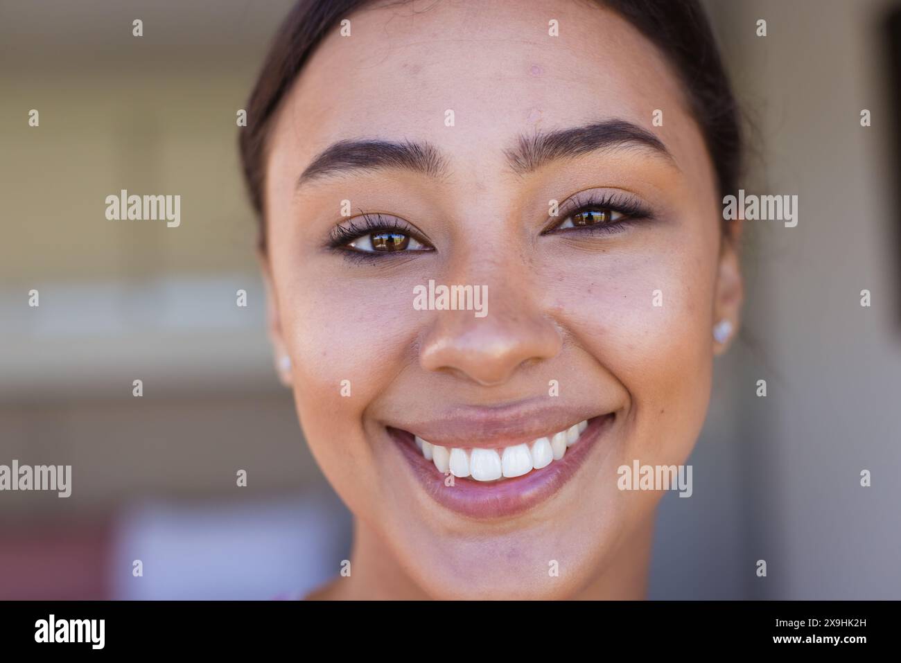 A biracial young female, smiling at home, showing joy Stock Photo - Alamy