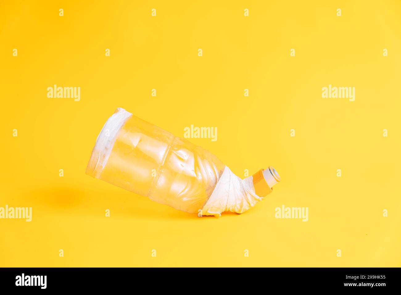 Recycling plastic inhaler bottles on yellow background Stock Photo - Alamy