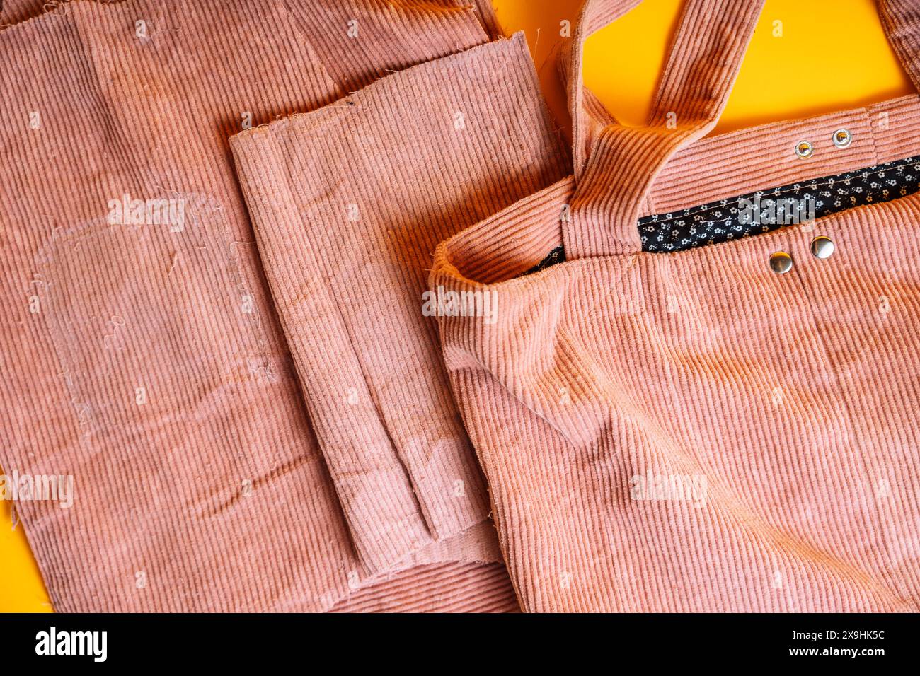 Bag made from old clothes on a yellow background Stock Photo - Alamy