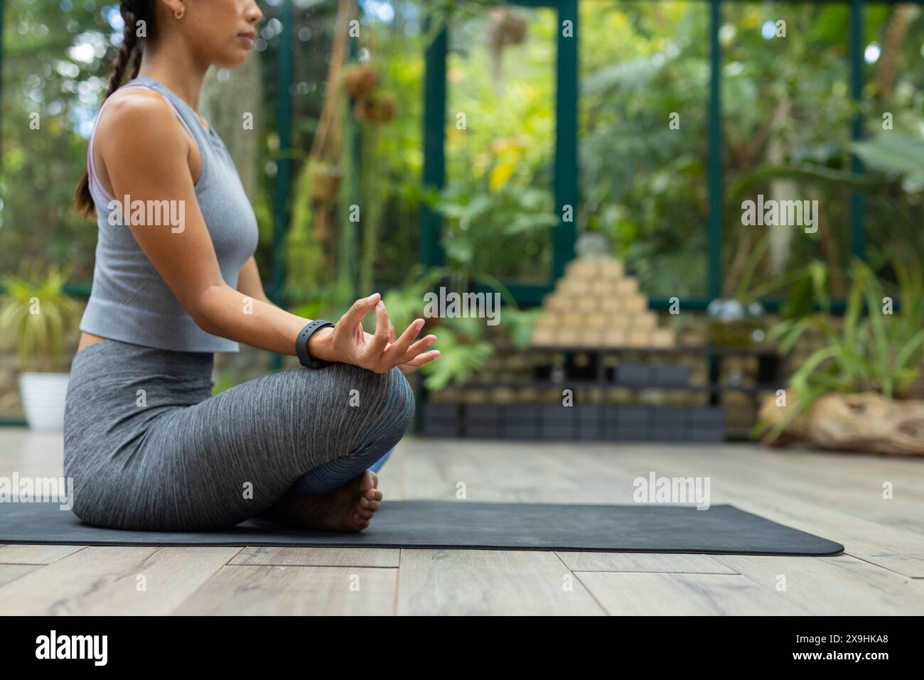 Glass house studio captures Pacific Islander woman in gray doing yoga ...