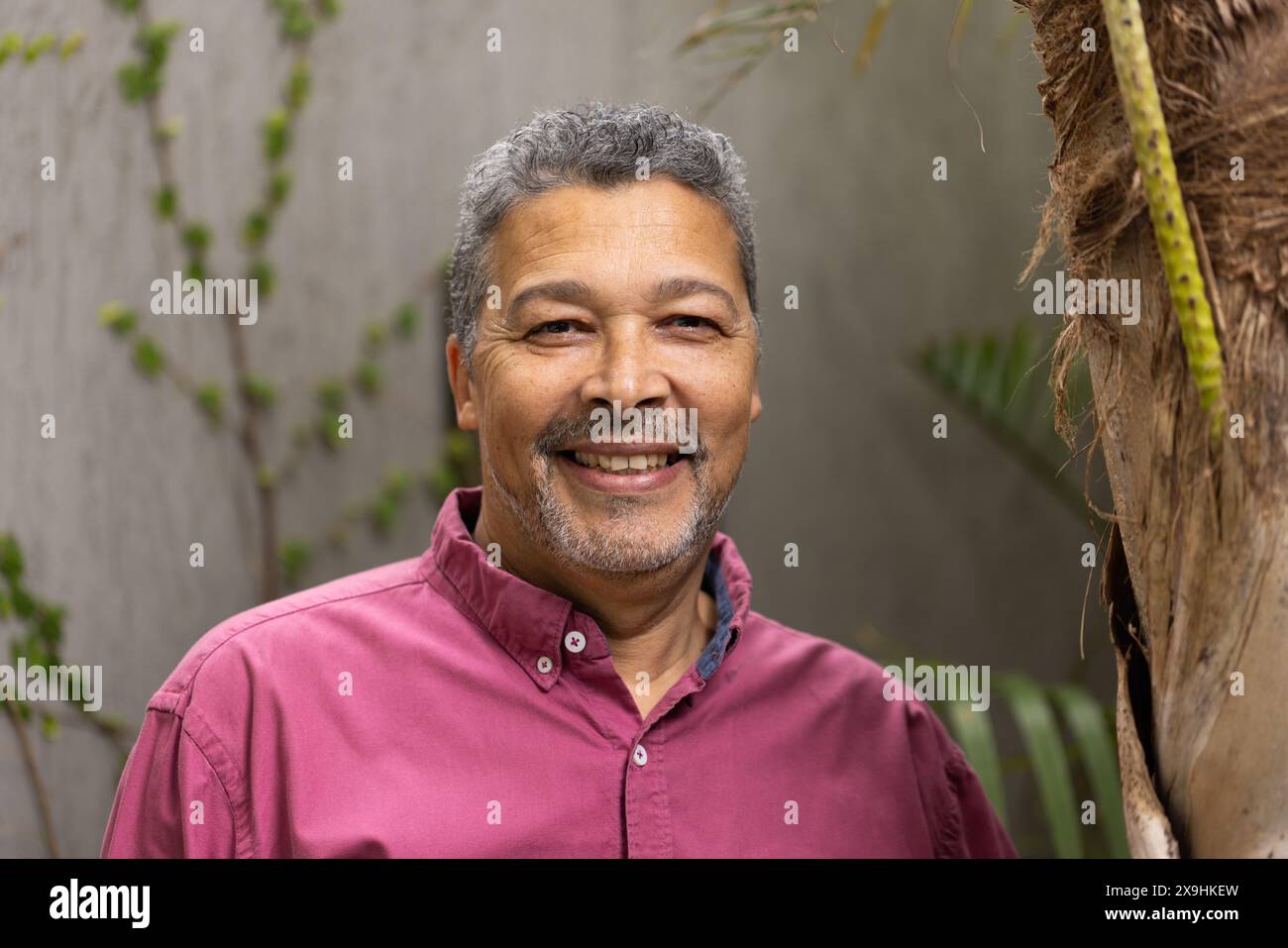 Biracial senior male with short gray hair and goatee smiling outdoors ...