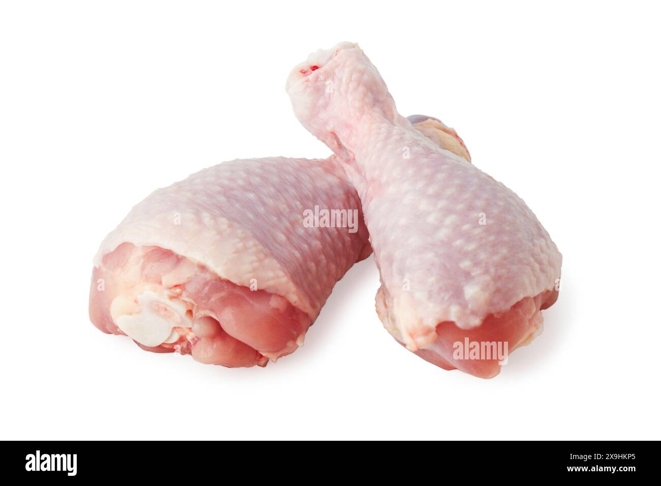 Raw chicken drumsticks closeup isolated on white background Stock Photo ...
