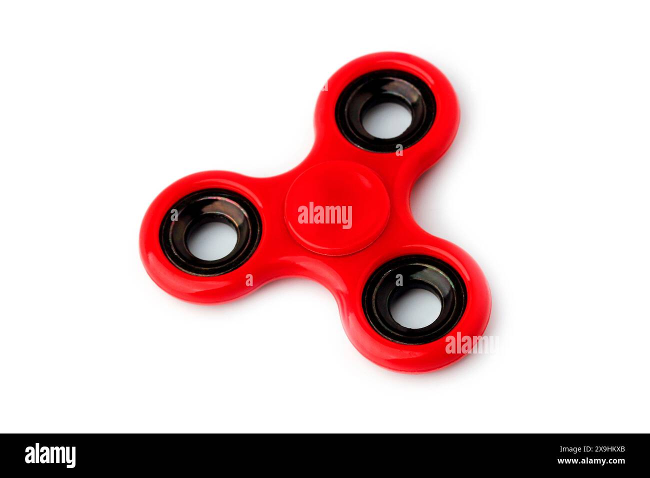 Red plastic spinner closeup isolated on white background Stock Photo ...