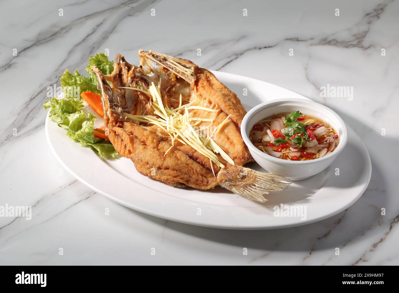 Deep fried sea bass fish with mango sweet and sour fish sauce dish food ...