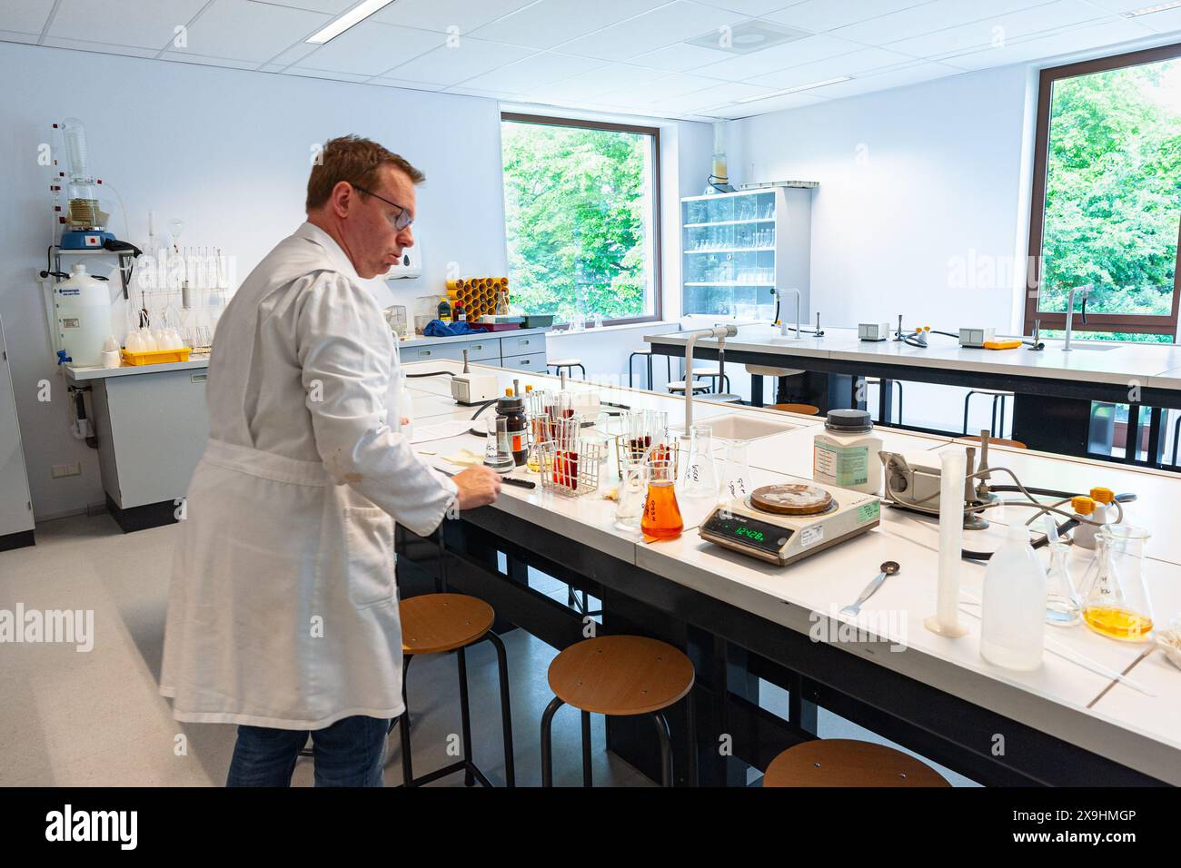 A lab technician performs chemical tests in a chemistry laboratory ...