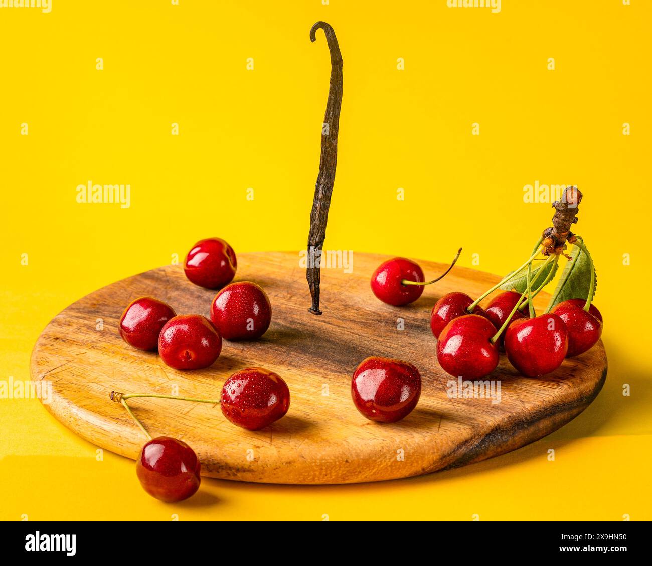 cherries and vanilla flavor concept on colored background, focus ...