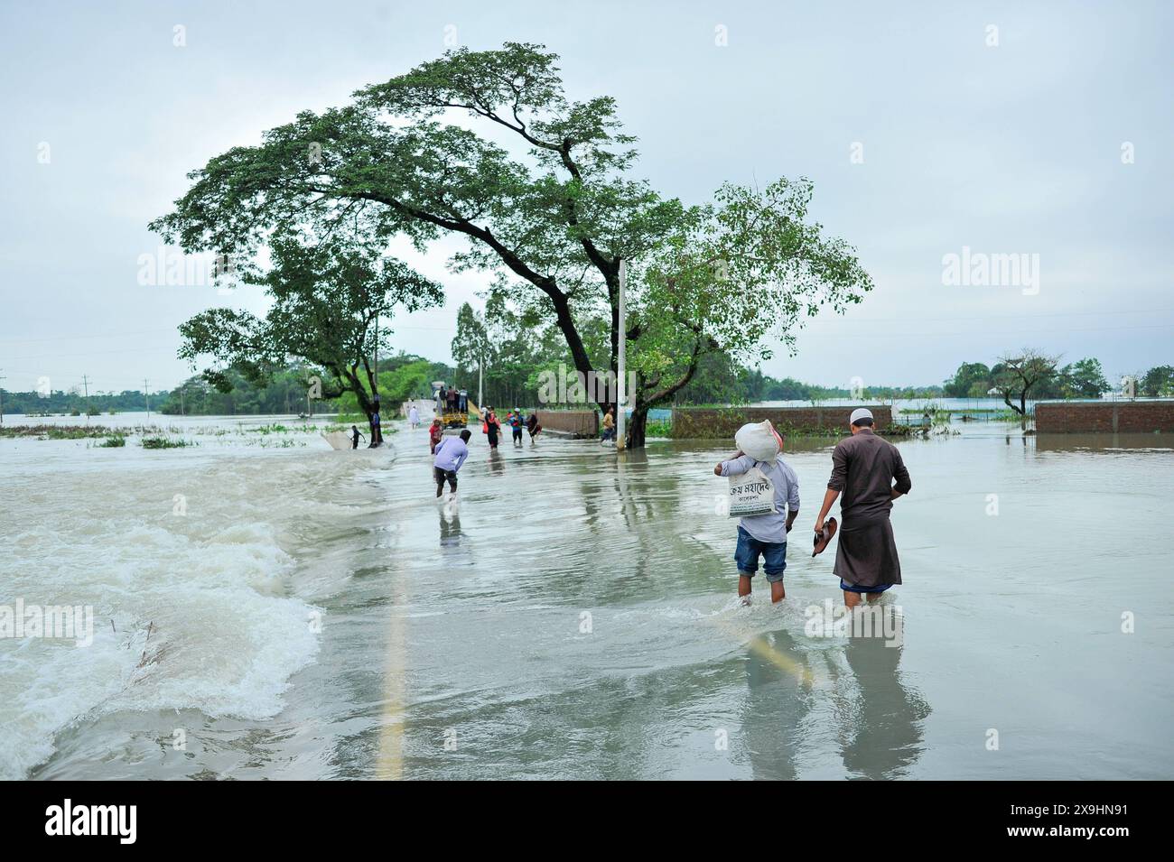 Cyclone Remal Hits Sylhet People struggling to wade through the flooded ...
