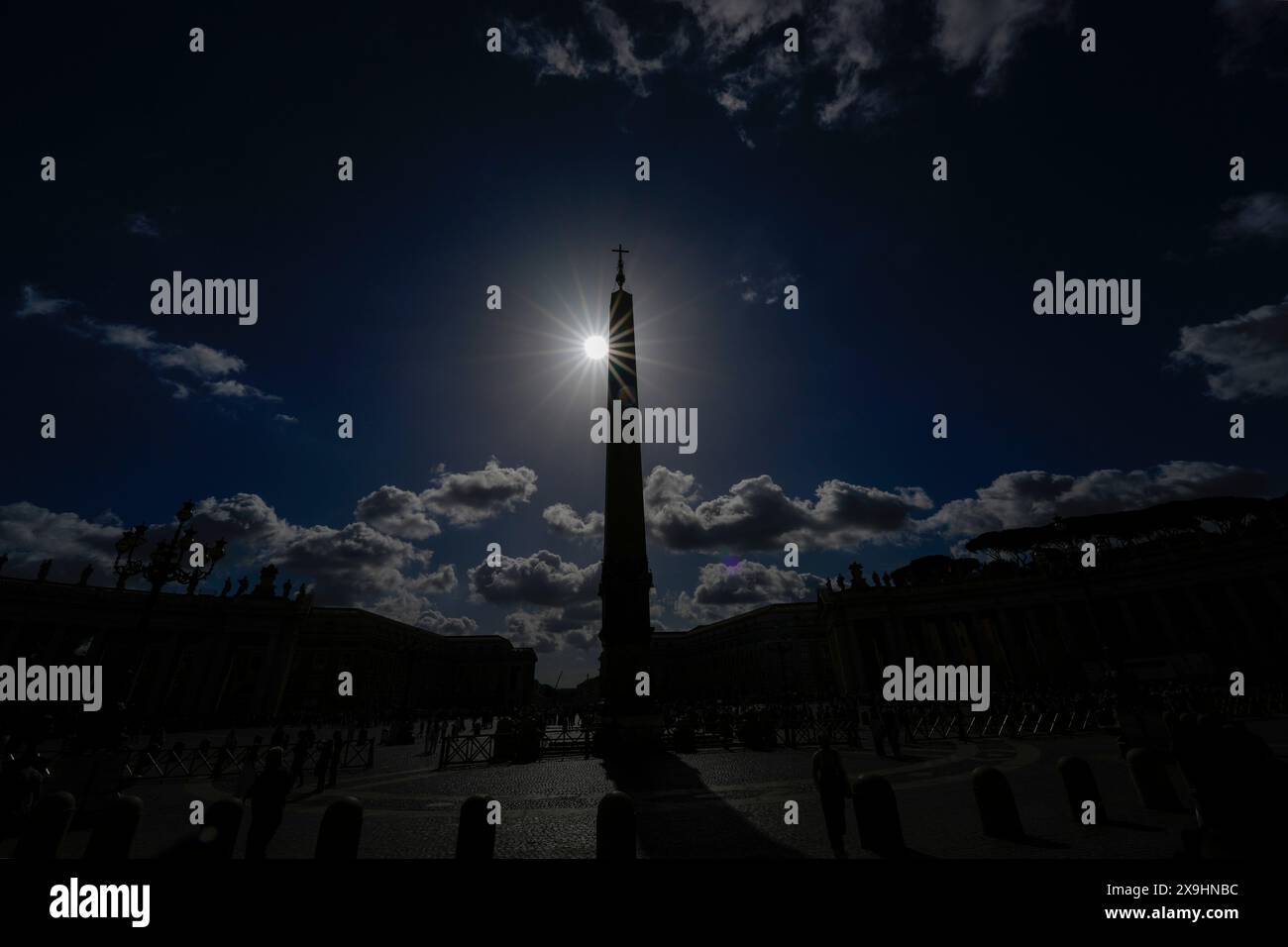 The sun shines behind the 25.5-meter-tall (84ft) Vatican Obelisk in St ...