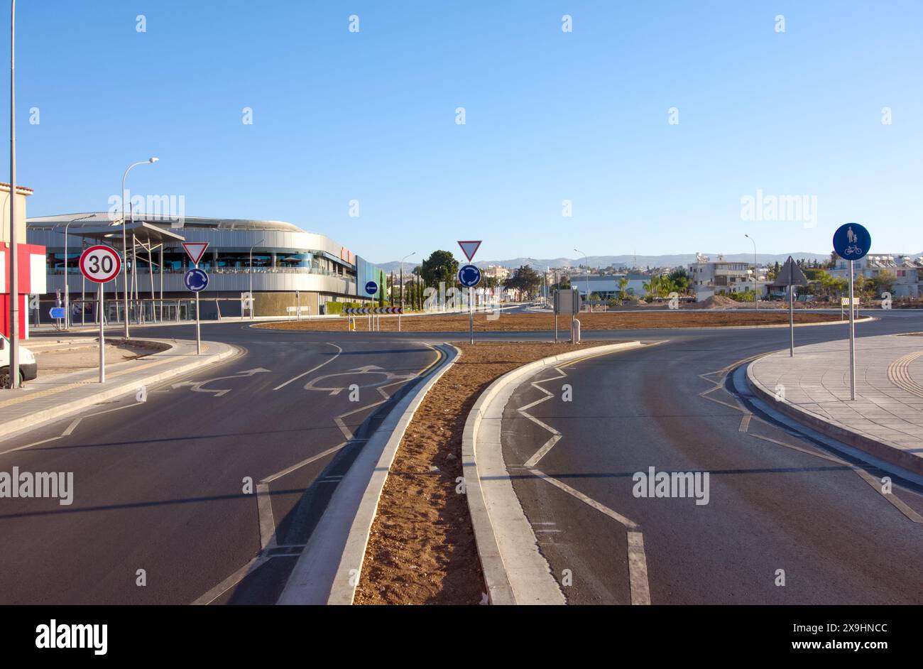 City roundabout with road markings and road signs. Urban scene Stock ...