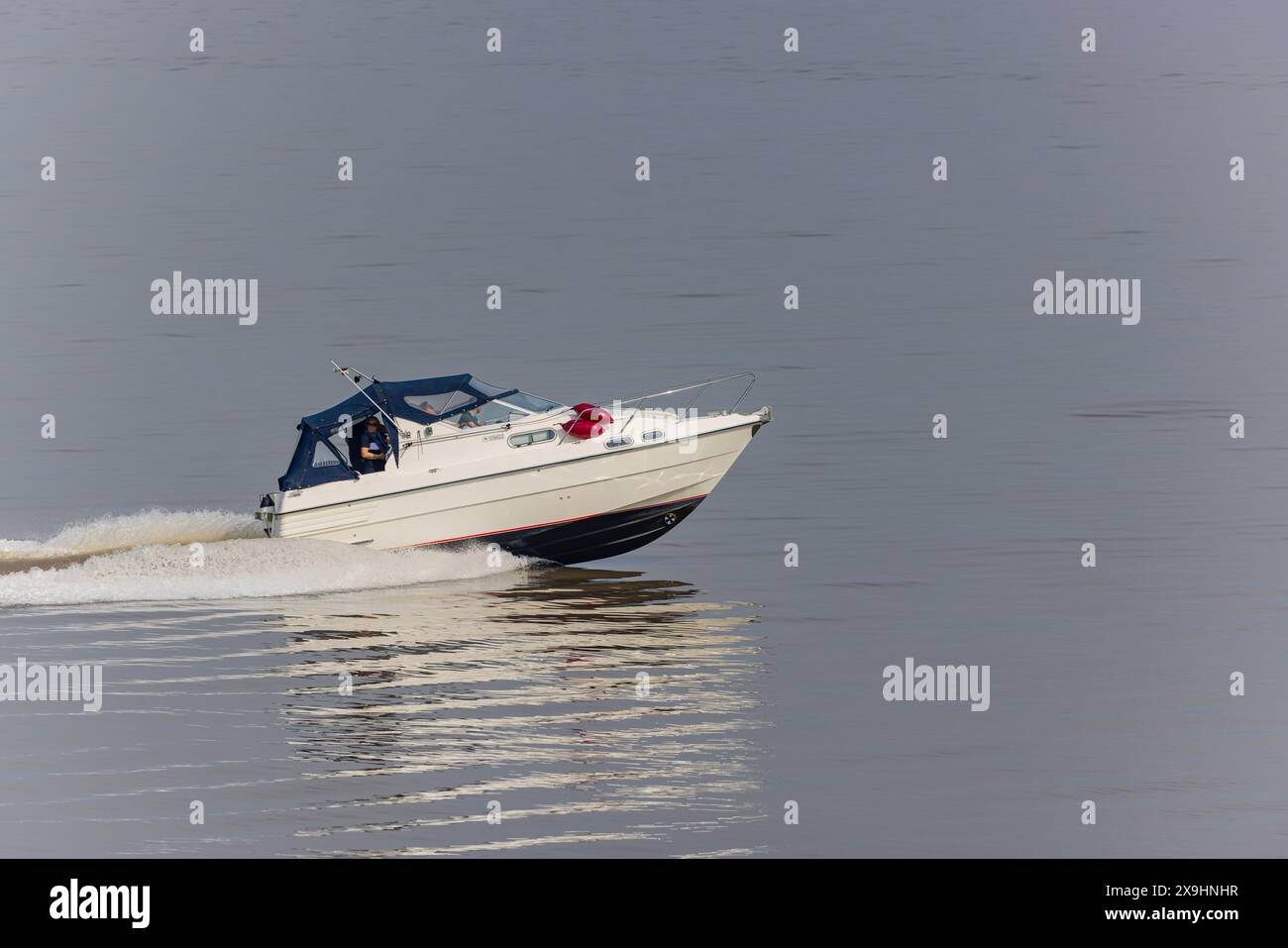 Pleasure craft moving at speed on a calm sea Stock Photo - Alamy