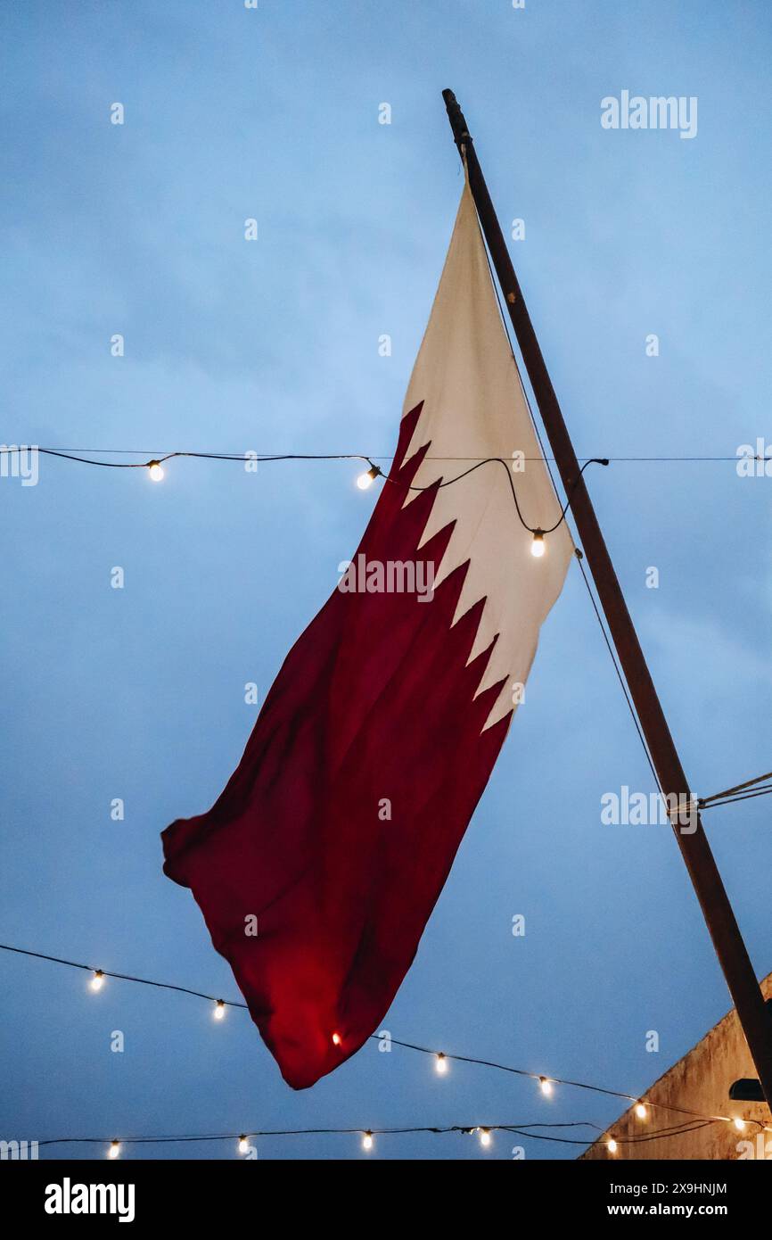 The waving flag of Qatar, in the Souq Waqif area of Doha Stock Photo ...