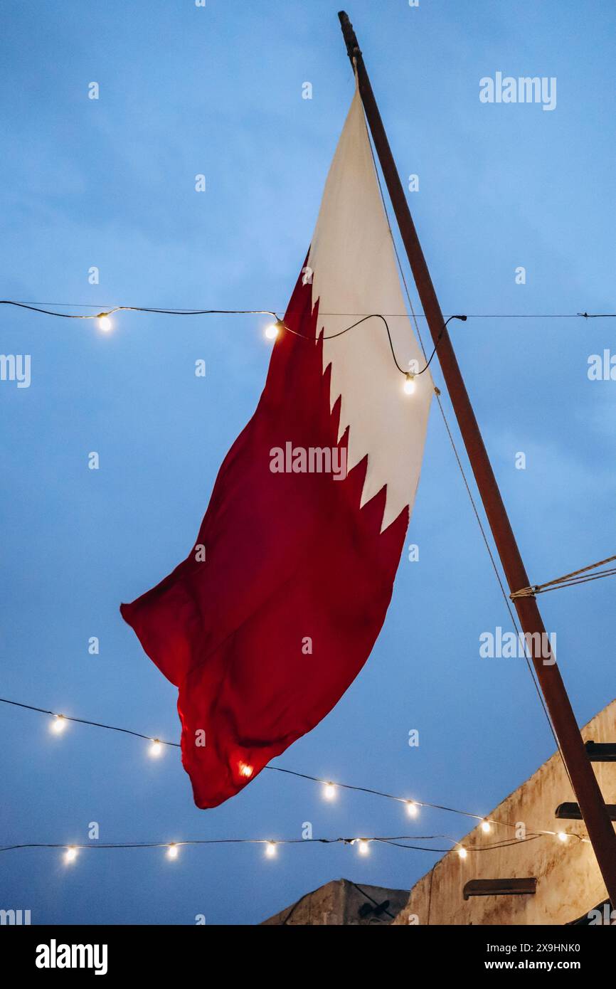 The waving flag of Qatar, in the Souq Waqif area of Doha Stock Photo ...