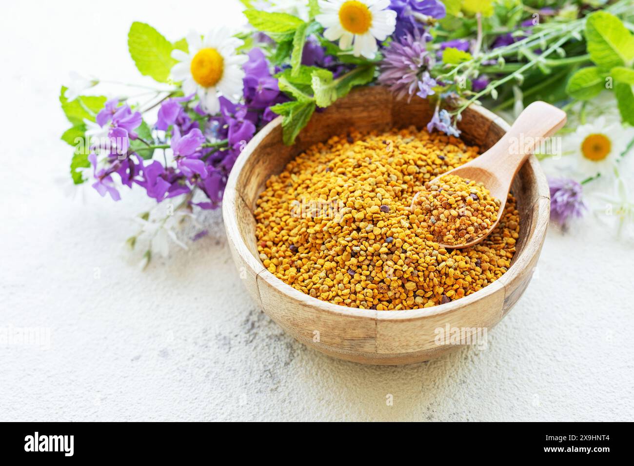Healthy bee pollen grains. Bee pollen on a bowl and wild flowers Stock ...