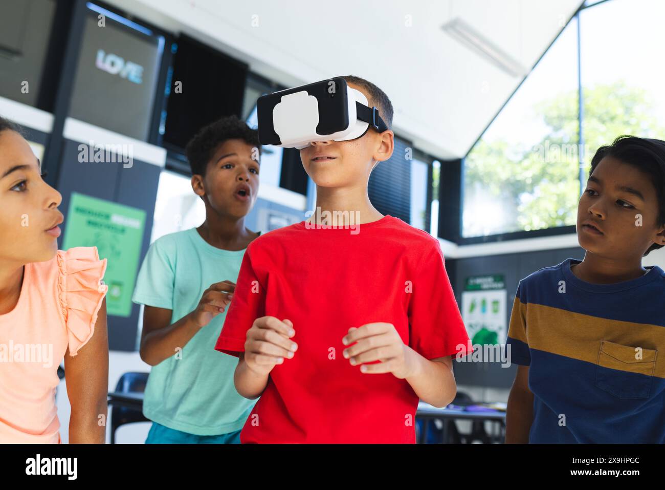 In school, diverse group of young students is exploring virtual reality ...