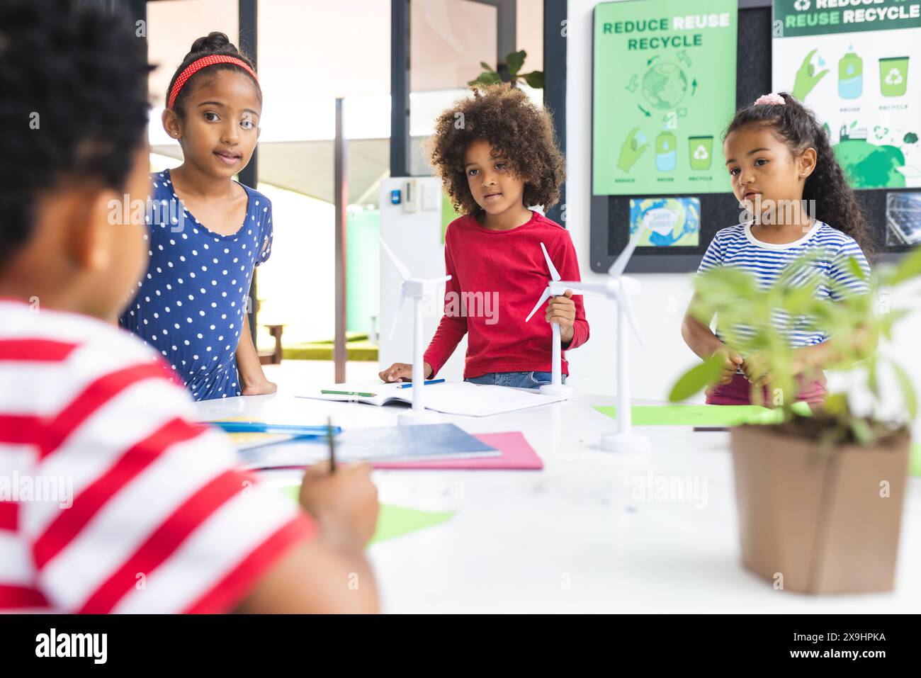 In school, diverse young students focus on a sustainability project in ...