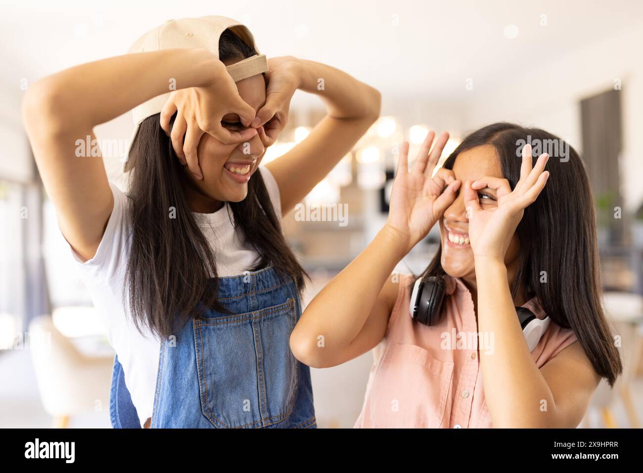 Biracial young sisters, laughing together at home Stock Photo - Alamy
