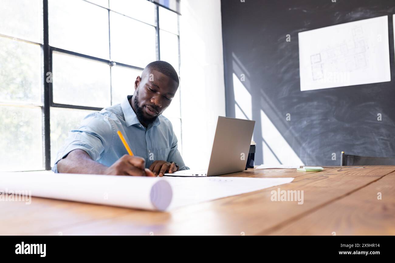 At modern business office, young African American man working on ...
