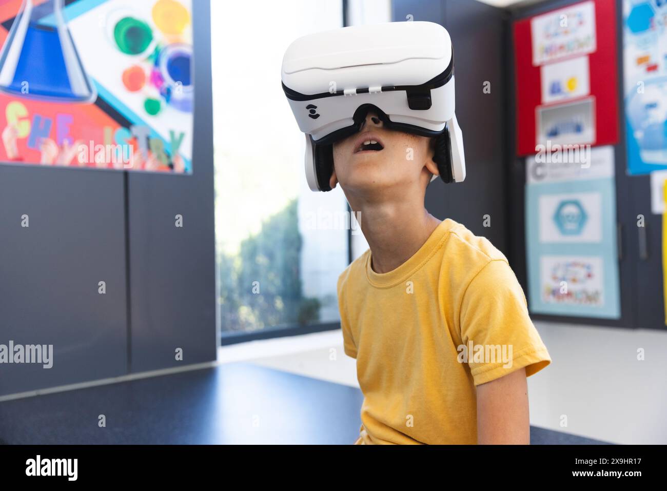 Biracial boy explores virtual reality in a school setting Stock Photo ...