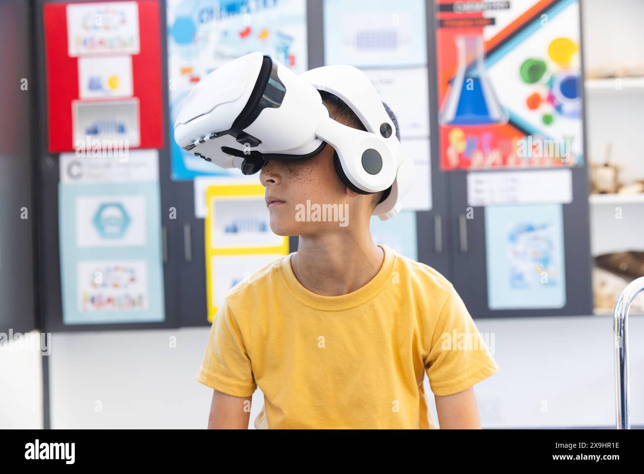 Biracial boy explores virtual reality in a classroom at school Stock ...