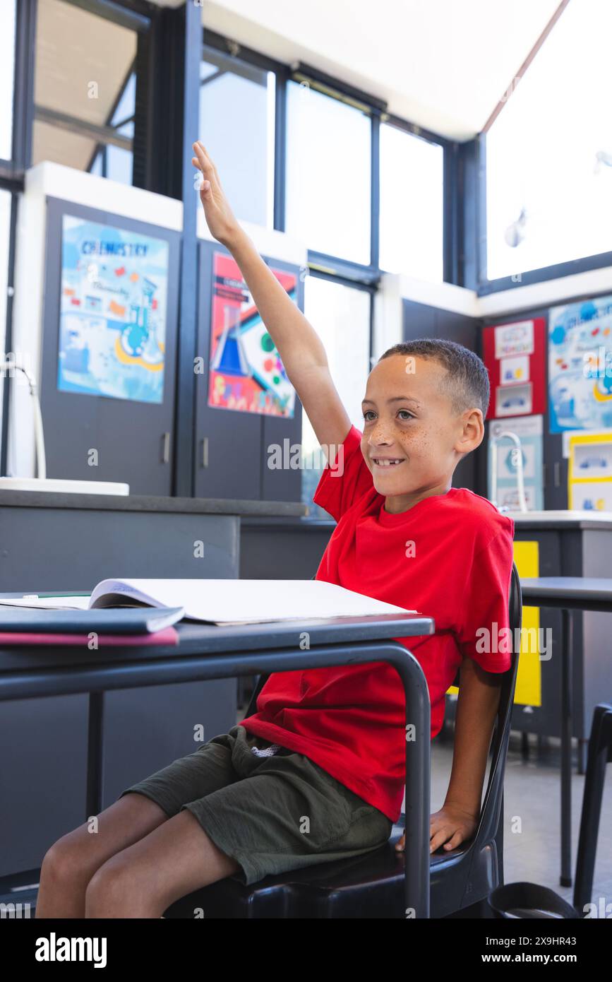 Eager boy raising hand in hi-res stock photography and images - Alamy