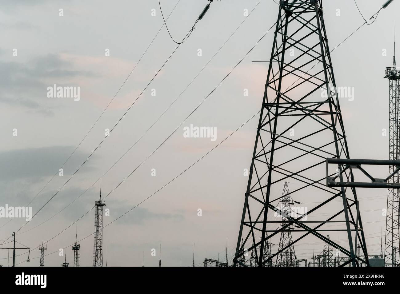 High voltage electric distribution network at sunset. Power ...