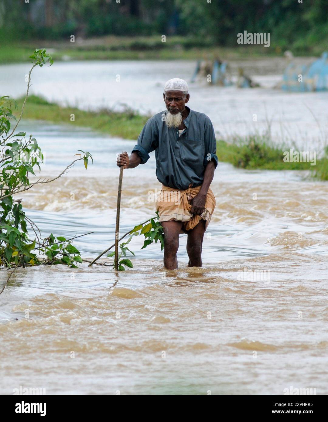 Sylhet, Bangladesh. 30th May 2024. Elderly residents struggle to wade ...