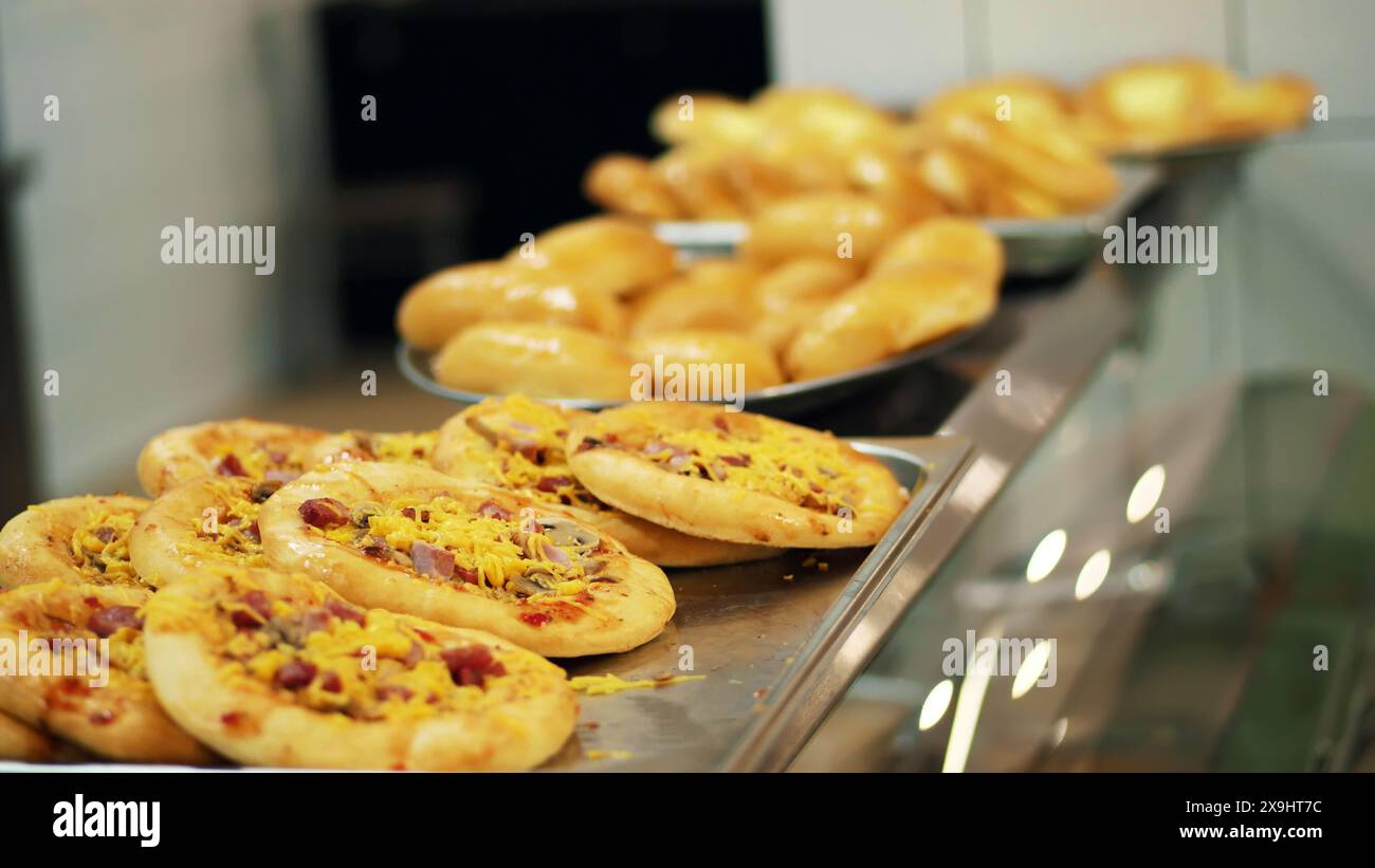 close-up, showcase with mini pizza, yeast dough baking in modern ...
