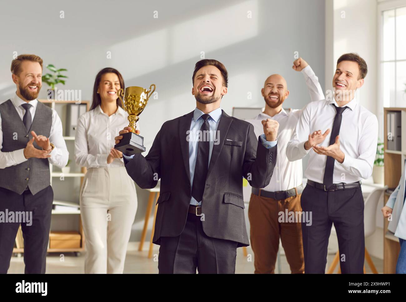 Smiling colleagues celebrating achievement hi-res stock photography and ...