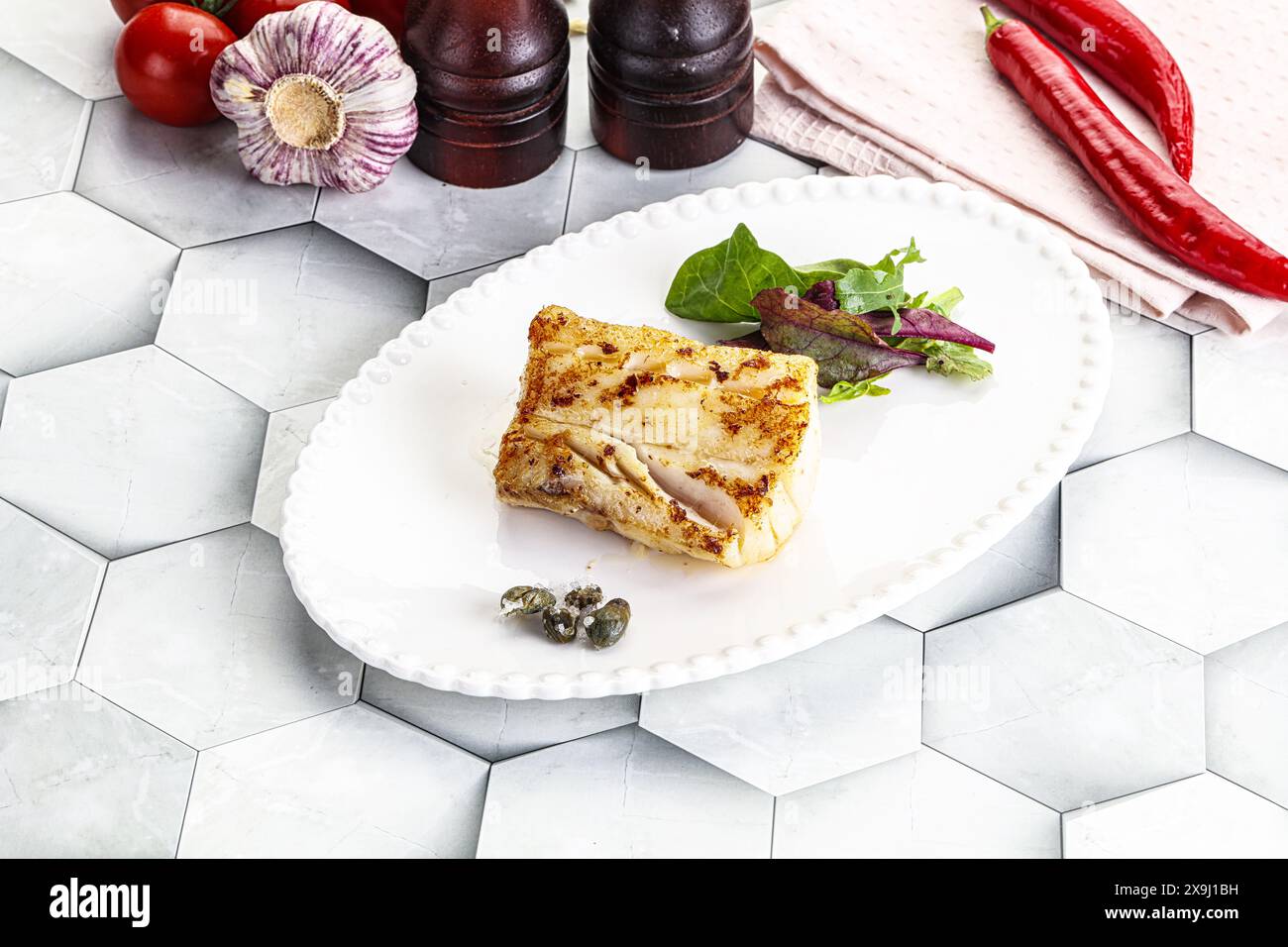 Roasted cod fish steak with salad leaves Stock Photo - Alamy