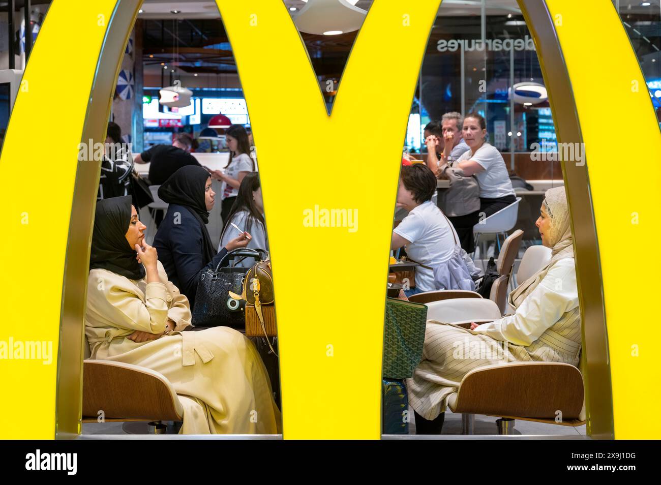 Flight passengers are seen eating a meal at the American fast-food ...