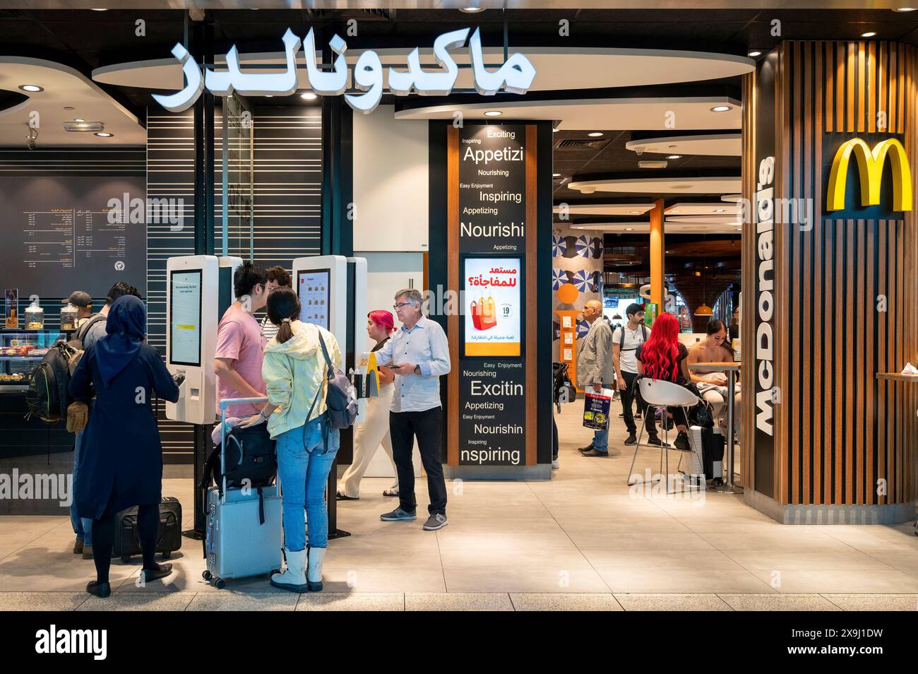 Flight passengers are seen at the American fast-food restaurant ...