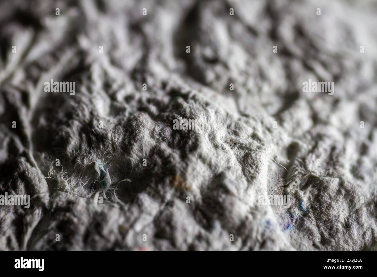 Extreme close up of old gray handmade paper mache with a structure and ...