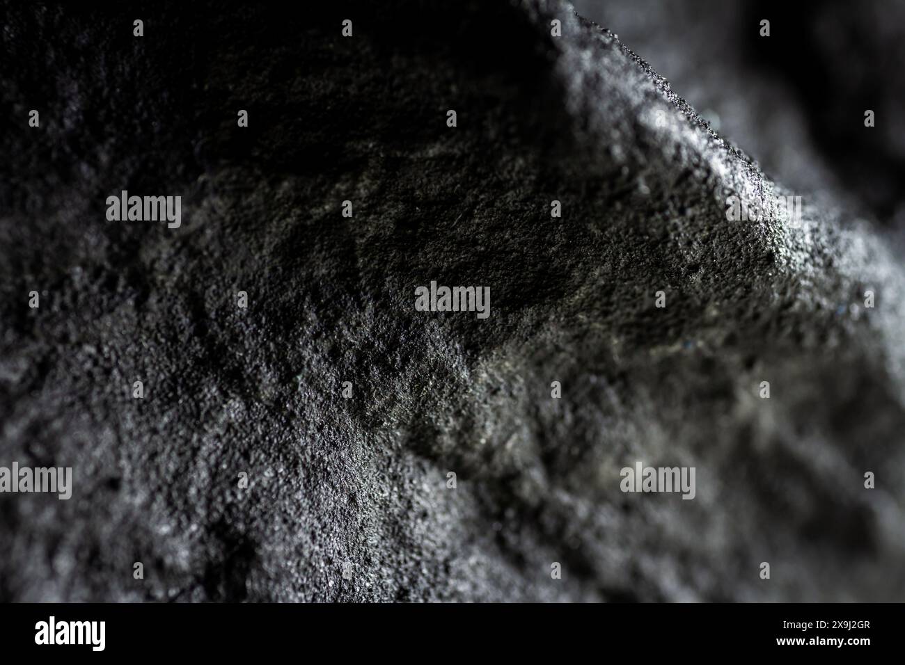 Extreme close up of painted in black handmade paper mache with a ...