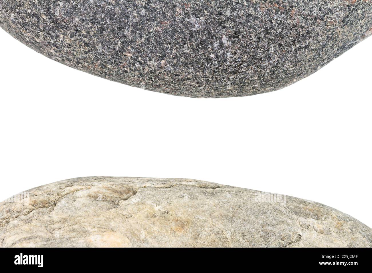 Edges of two pebbles isolated on white background with a space for text ...
