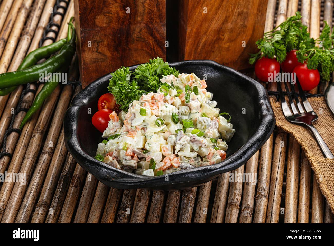 Traditional Russian salad with mayonnaise, meat, potato and peas Stock ...