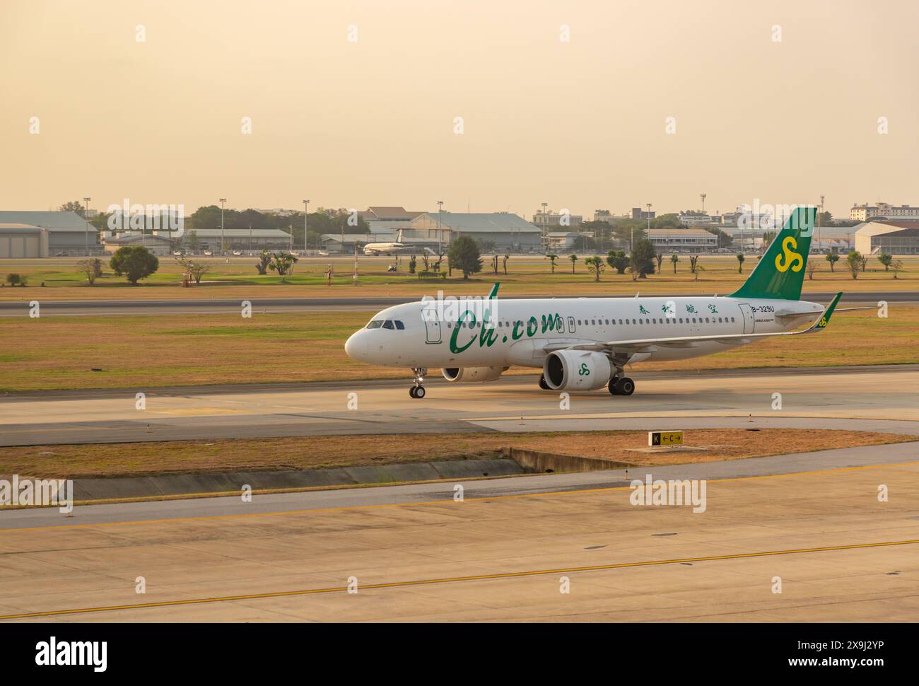A picture of an Spring Airlines plane at sunrise Stock Photo - Alamy
