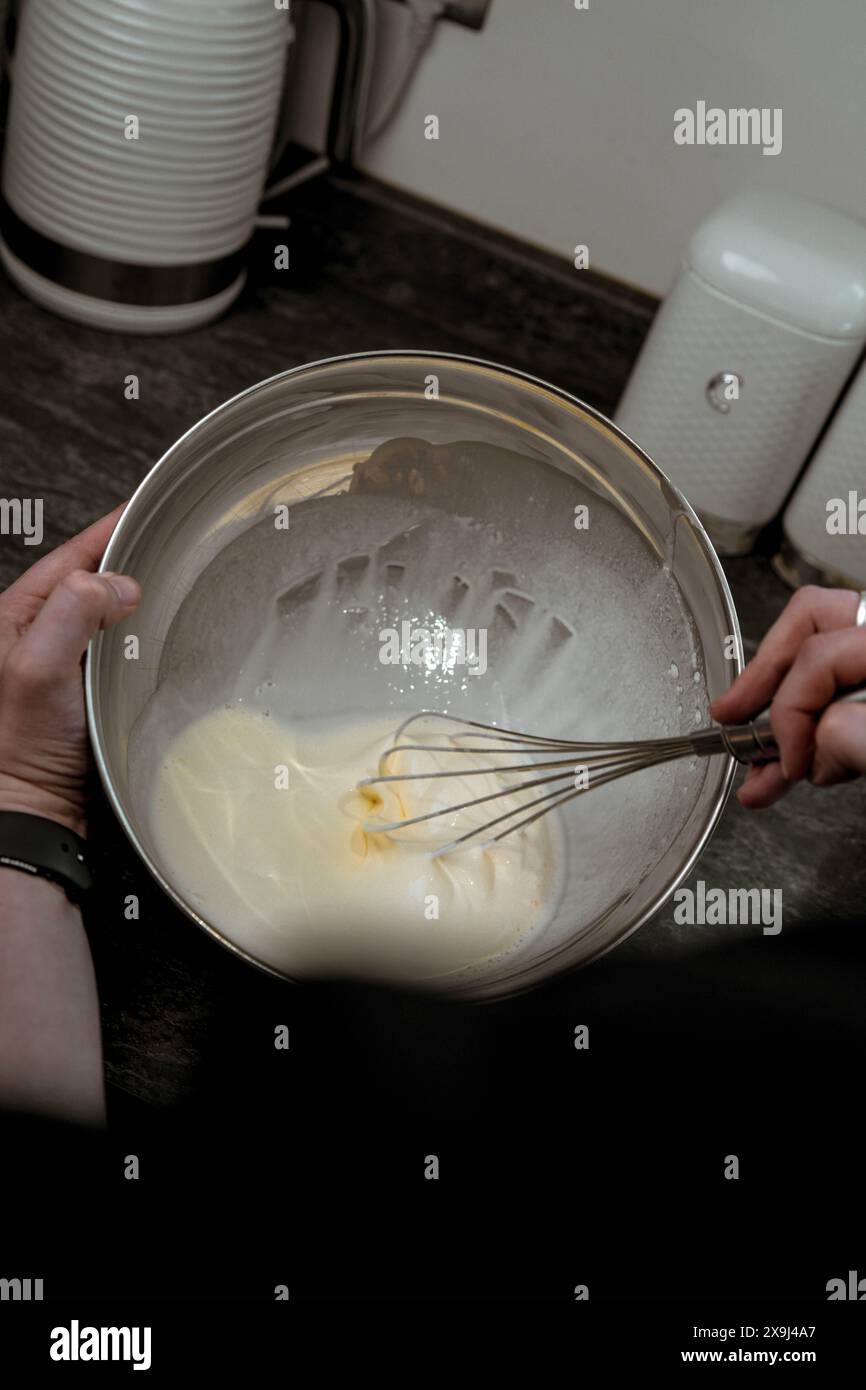 Cake mixture being whisked in a bowl Stock Photo - Alamy