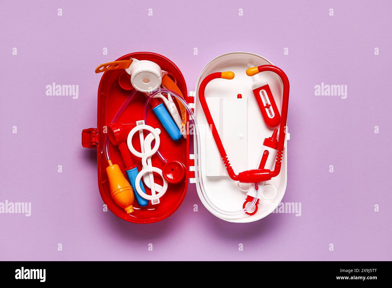 Open toy first aid kit on lilac background. Top view Stock Photo - Alamy