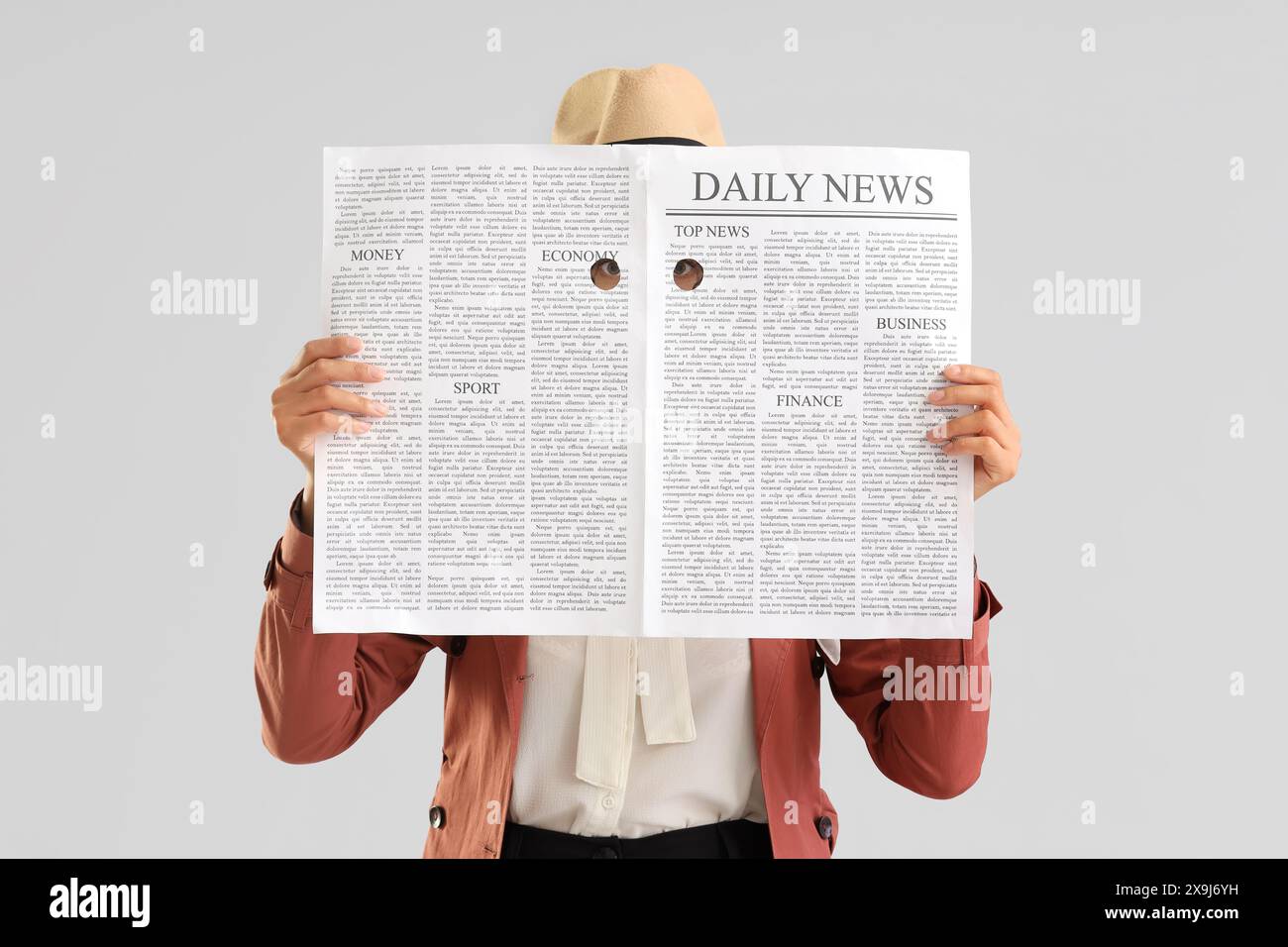 Female spy with newspaper on light background Stock Photo - Alamy