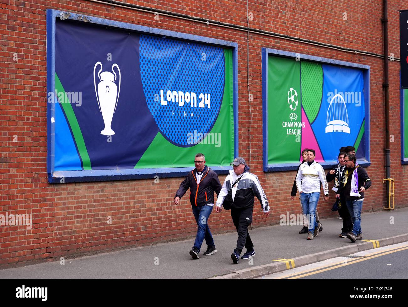 Real Madrid fans walk by London '24 Final signage before the UEFA ...