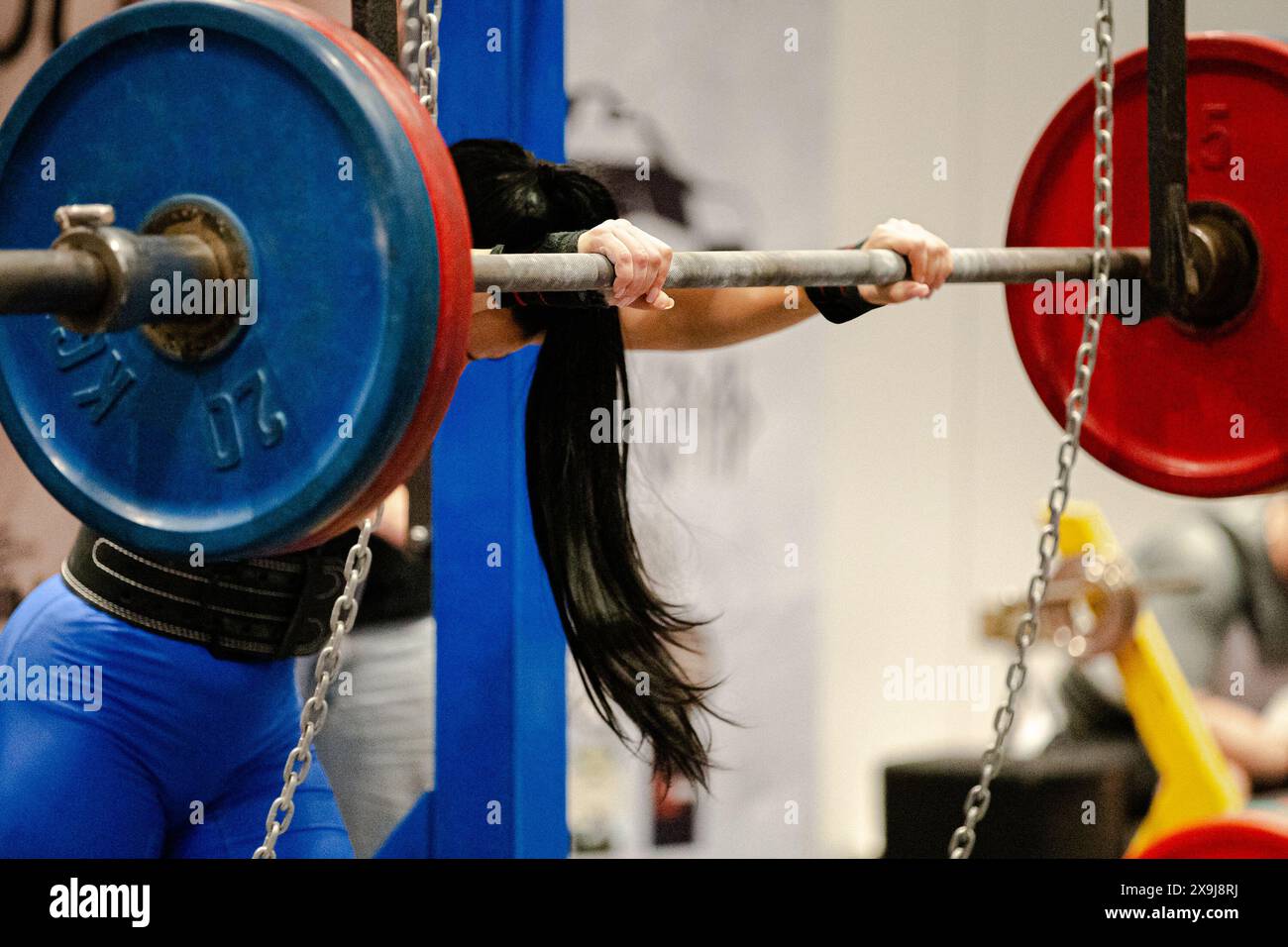 barbell for squat on monolith, woman athlete preparing to strength ...
