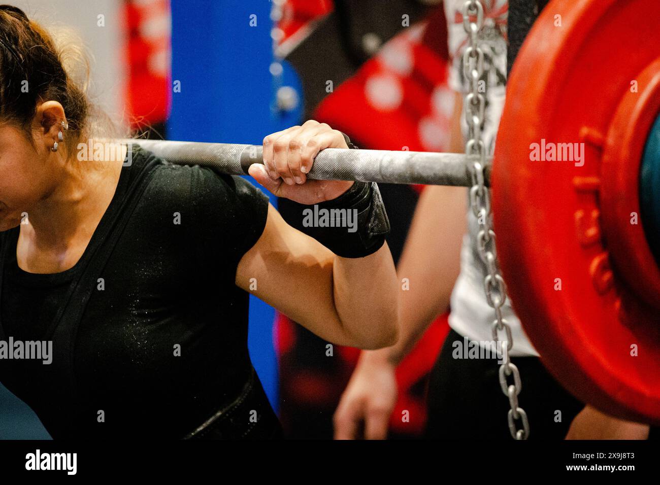woman athlete preparing squat exercise at powerlifting competition ...