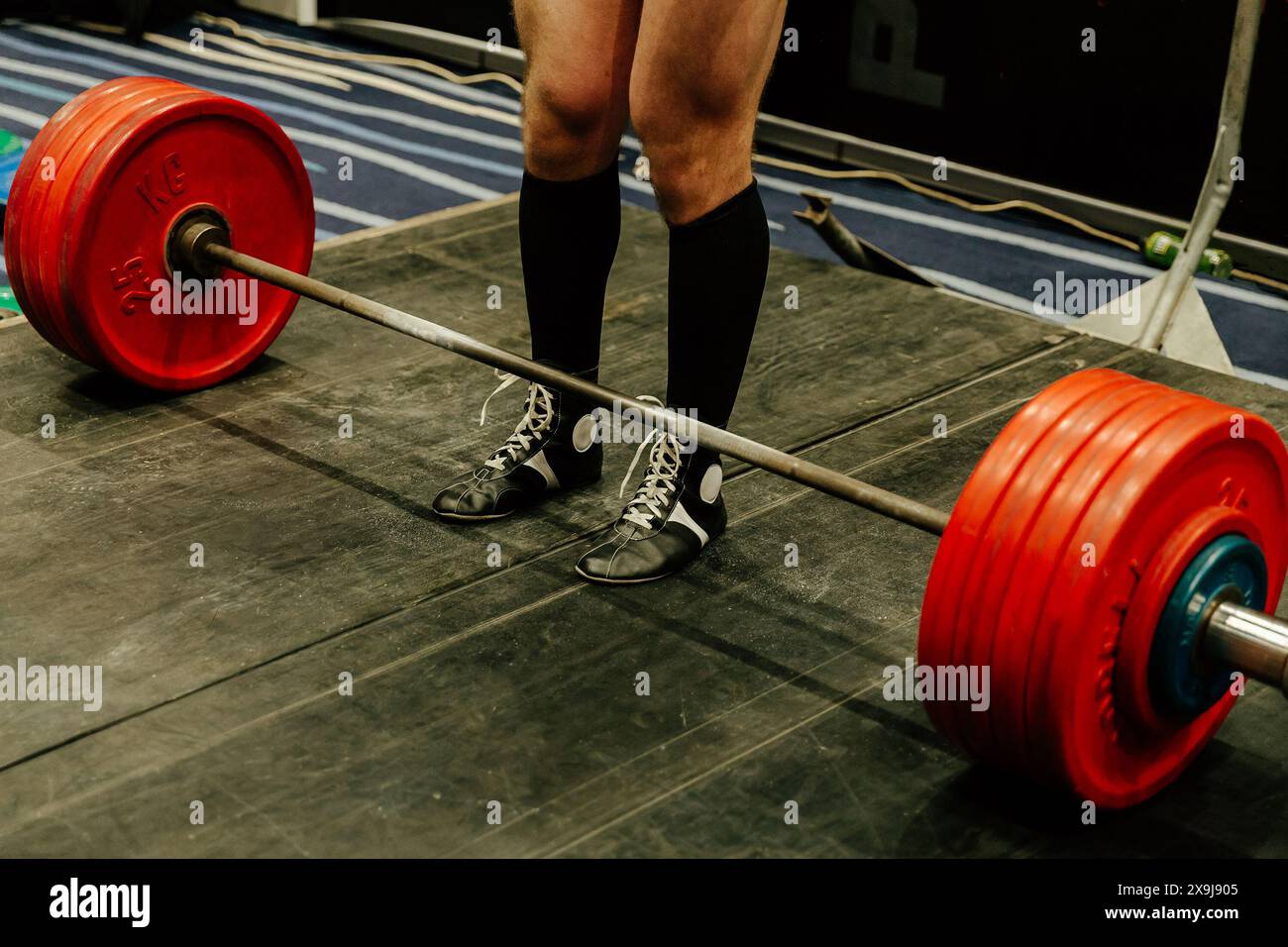 deadlift exercise at powerlifting competition, legs man in black knee ...