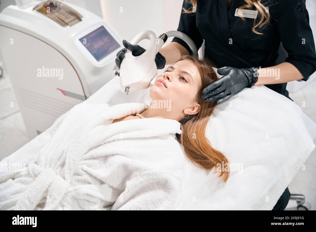 Beautician doing laser depilation with laser hair removal machine of ...