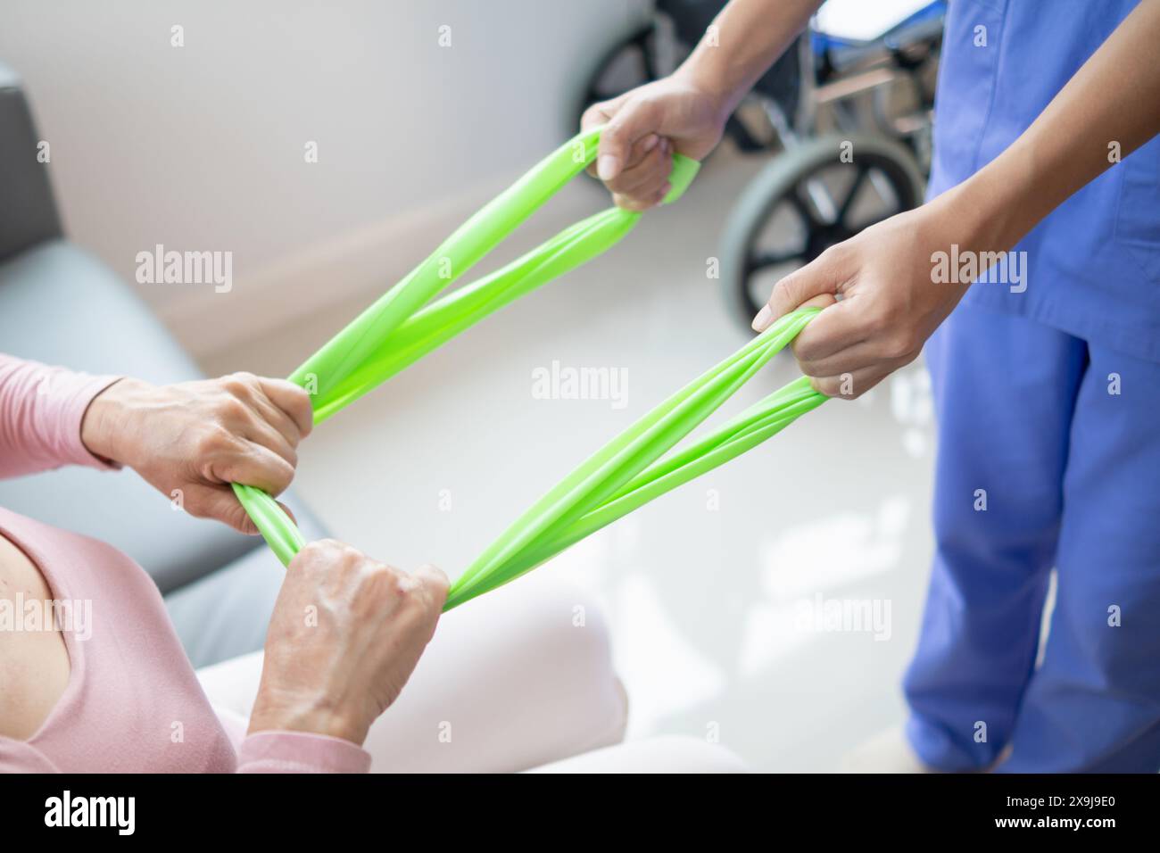 female doctor using elastic bands help patient regain muscle movement ...