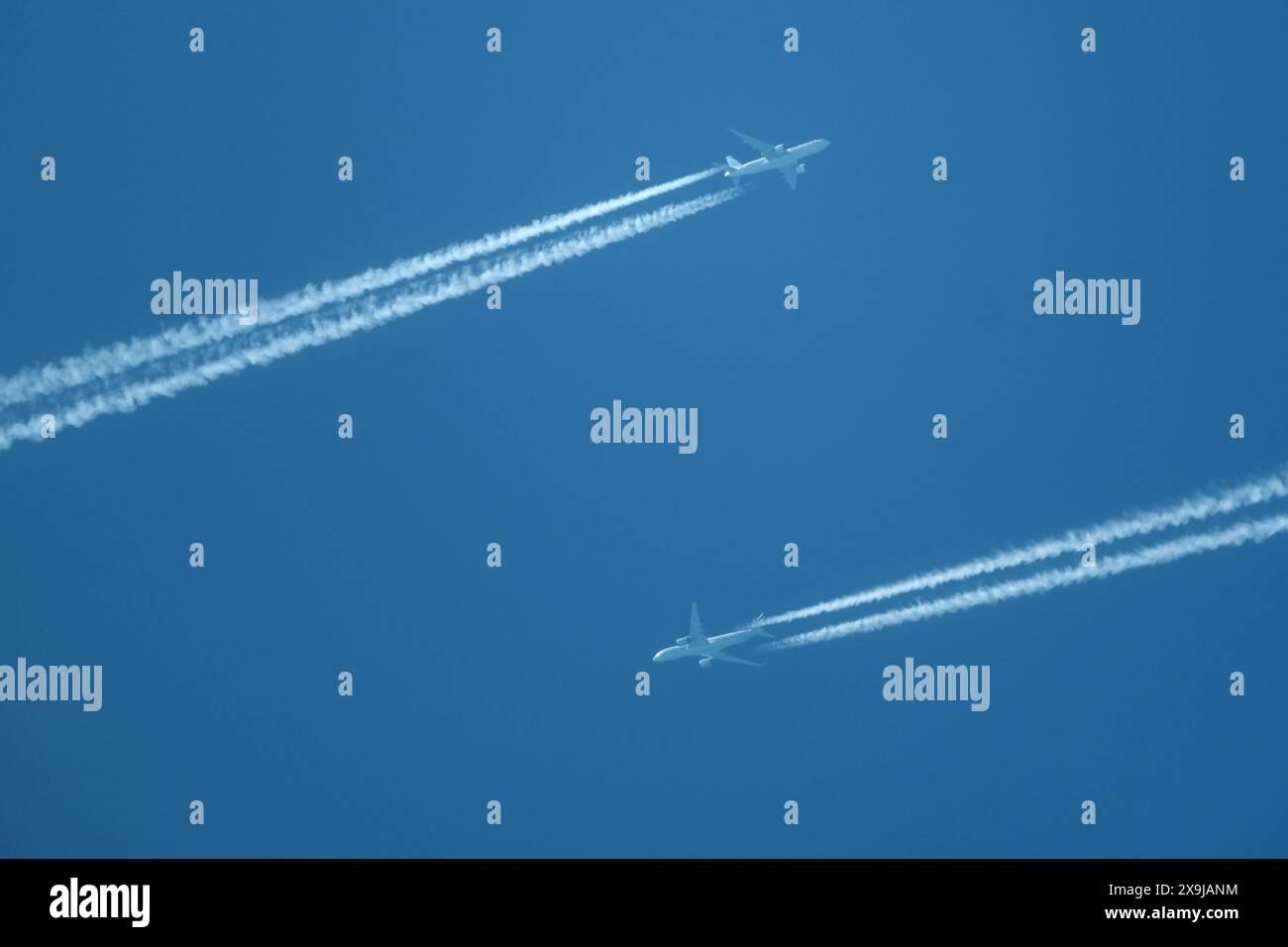 two planes in the sky, two airplane tracks in the blue sky, contrails ...