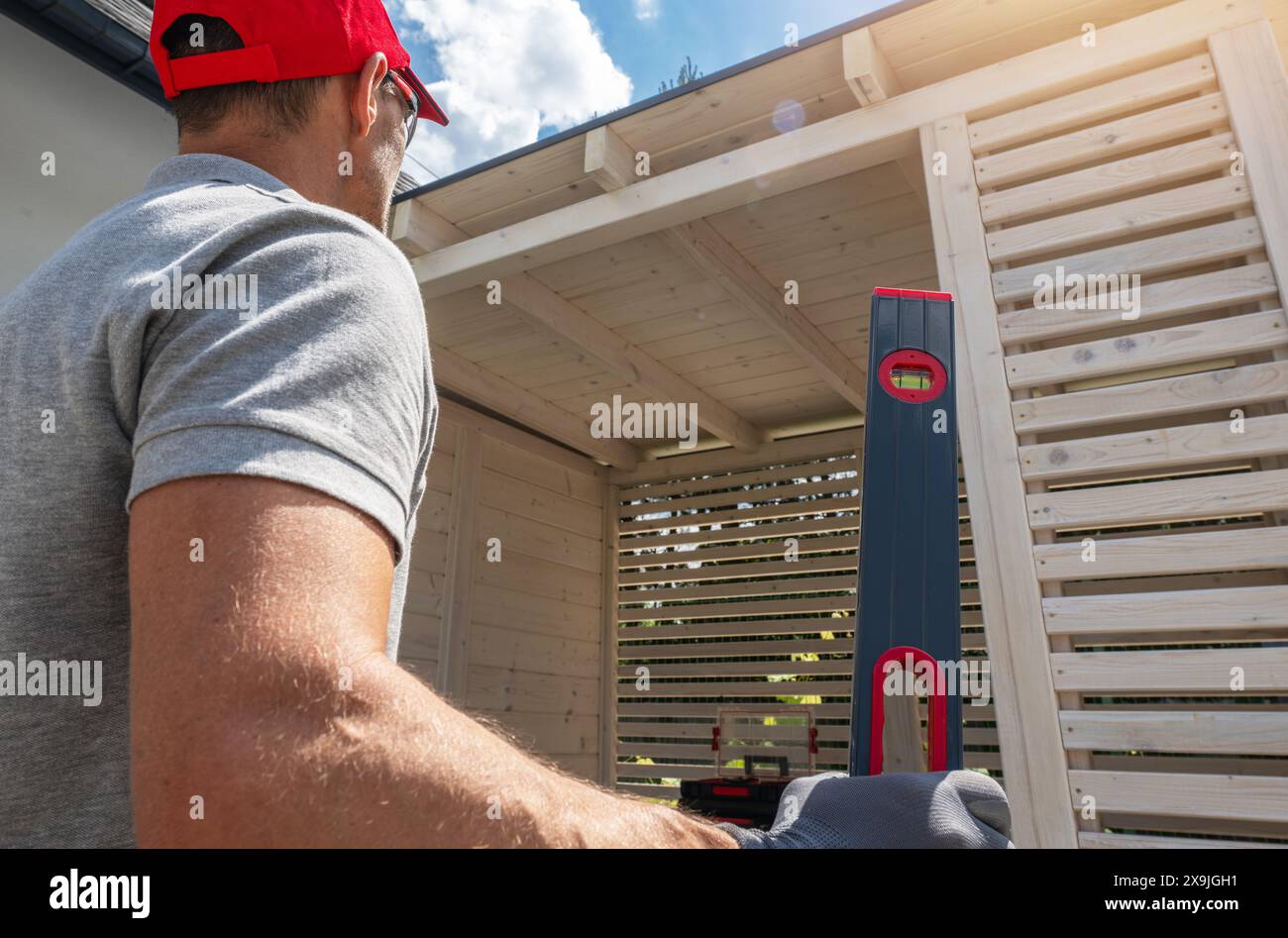 Construction Worker Checking Level of Wooden Structure Stock Photo - Alamy