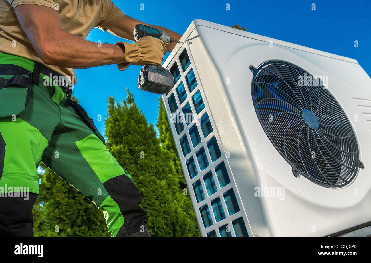 Technician Installing Hat Pump Unit Outdoors Stock Photo - Alamy