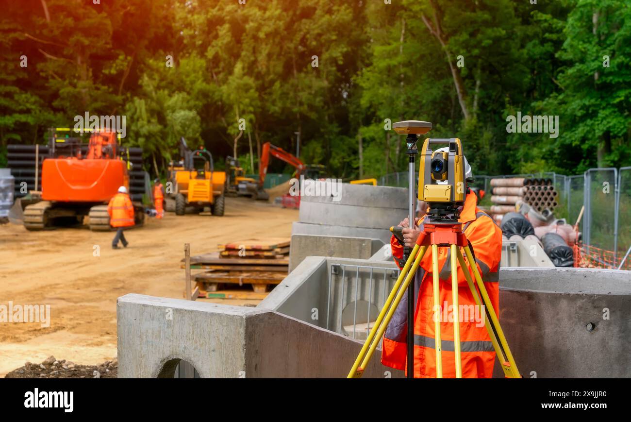 Surveyor site engineer with total positioning station on the ...