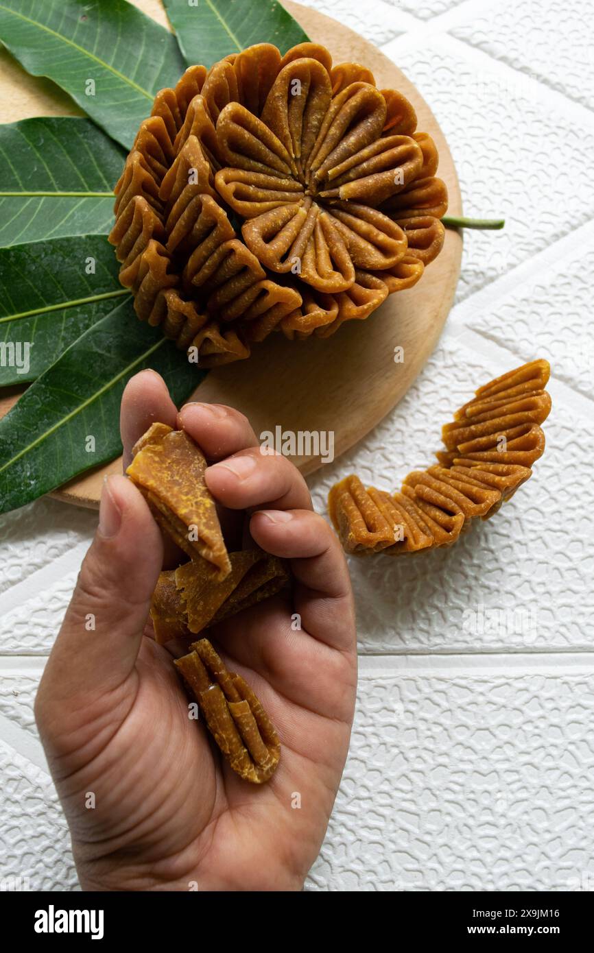 Hand holding Sun dried Mango Sheet Stock Photo - Alamy